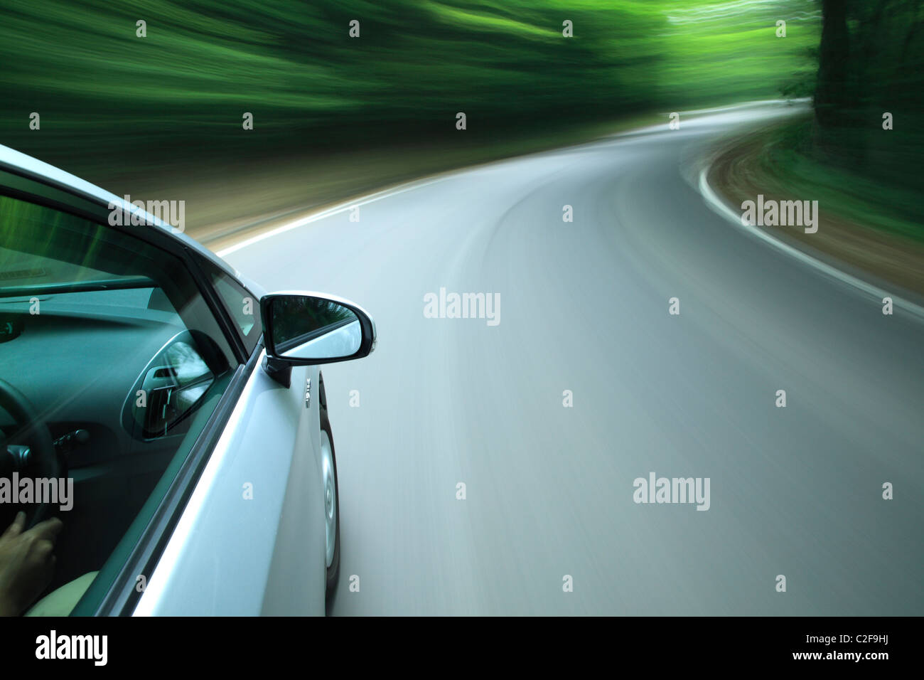 car driving fast into forest Stock Photo - Alamy