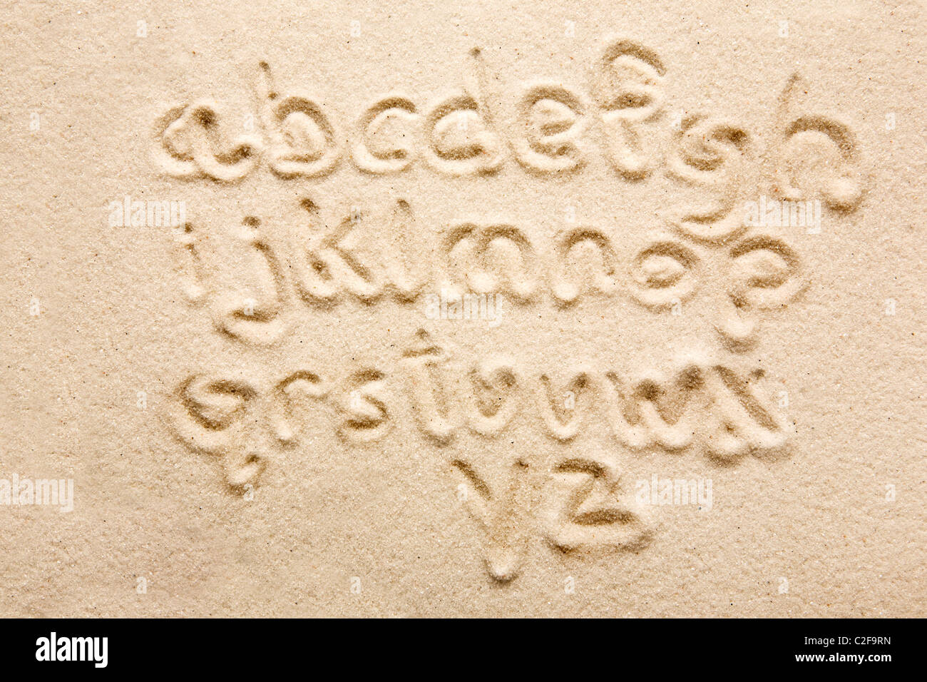 lower case alphabet written in sand - a designers tool Stock Photo - Alamy