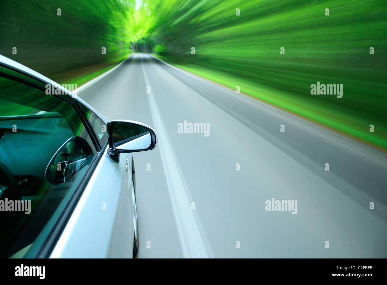 car driving fast into forest Stock Photo - Alamy
