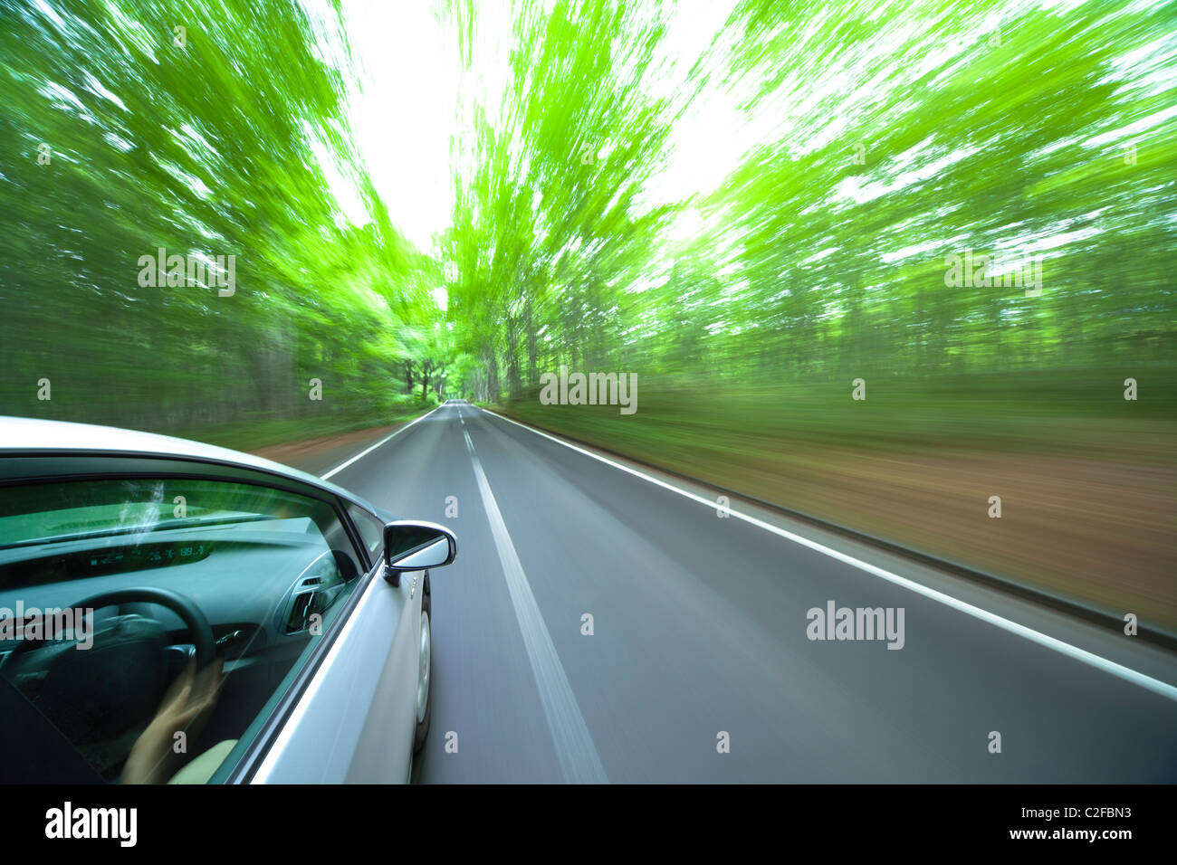 car driving fast into forest Stock Photo - Alamy