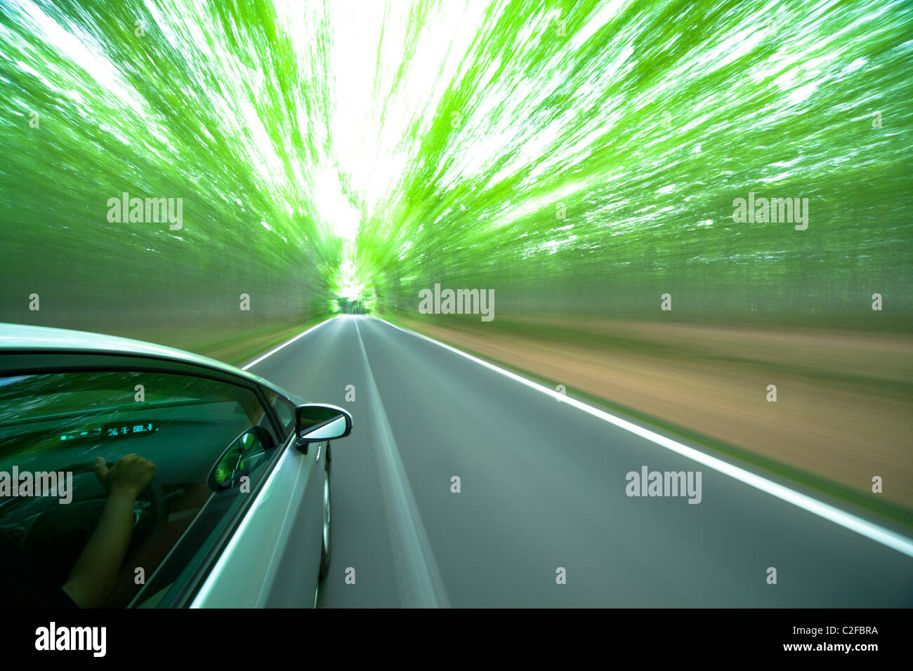 car driving fast into forest Stock Photo - Alamy