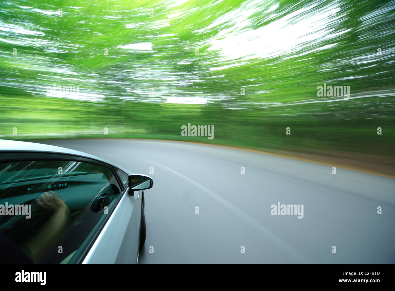car driving fast into forest Stock Photo - Alamy