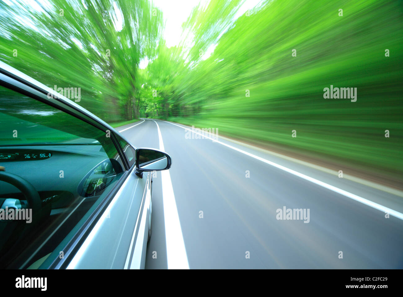 car driving fast into forest Stock Photo - Alamy