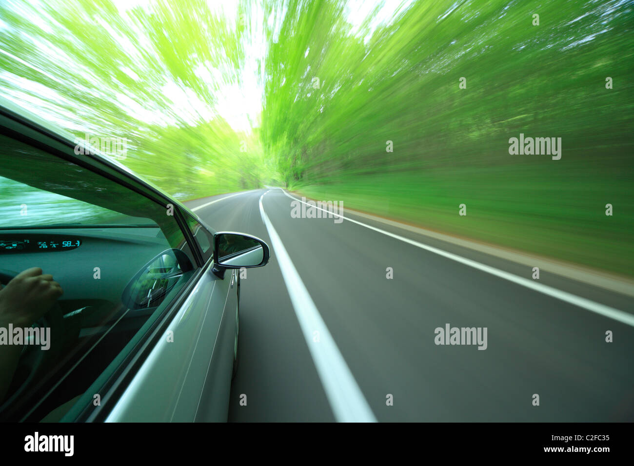 car driving fast into forest Stock Photo - Alamy