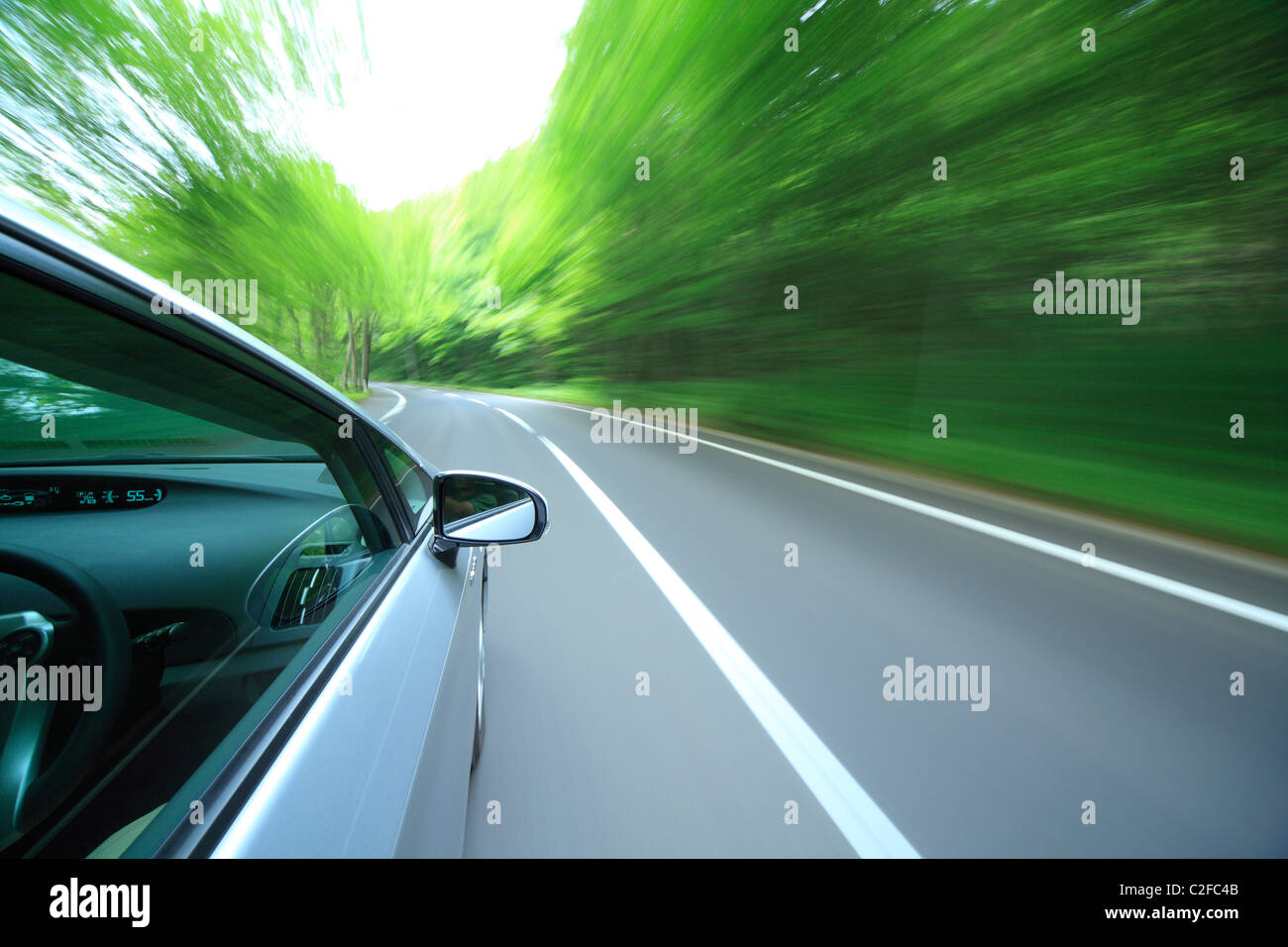 car driving fast into forest Stock Photo - Alamy