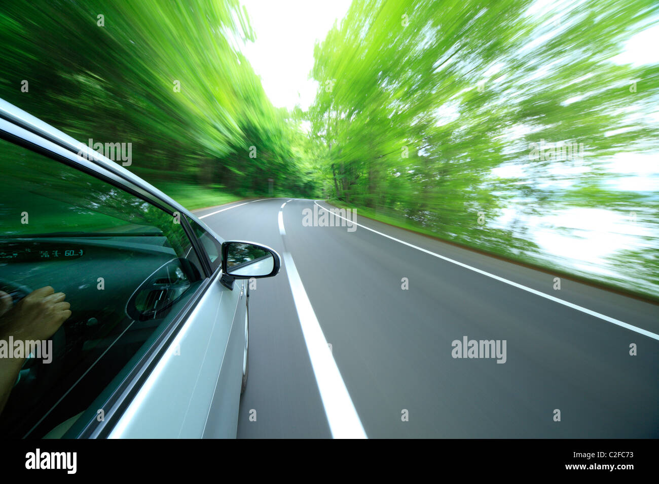 car driving fast into forest Stock Photo - Alamy