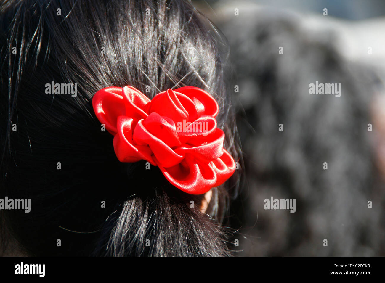 woman wearing red ribbon hair tie Stock Photo - Alamy