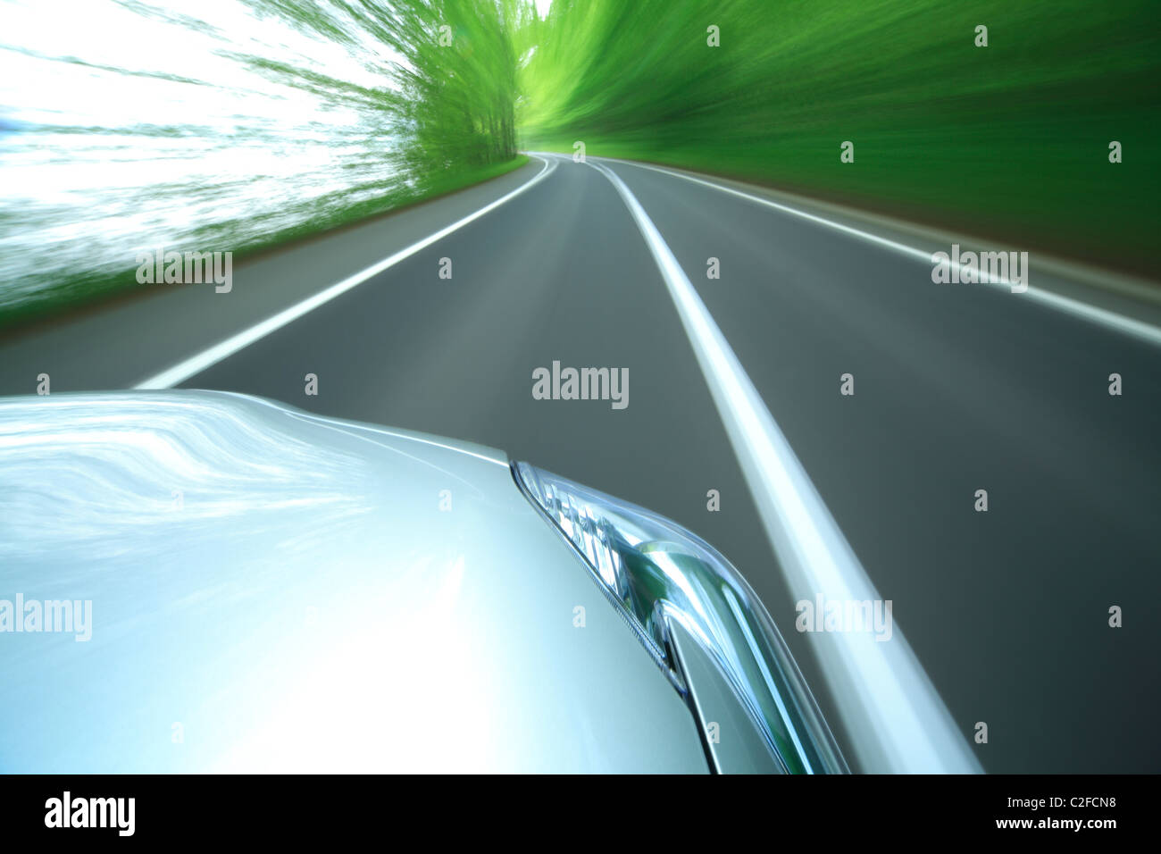 car driving fast into forest Stock Photo - Alamy