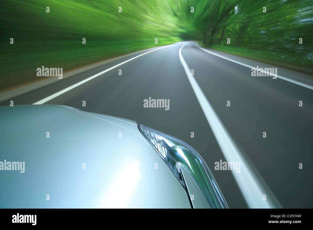car driving fast into forest Stock Photo - Alamy