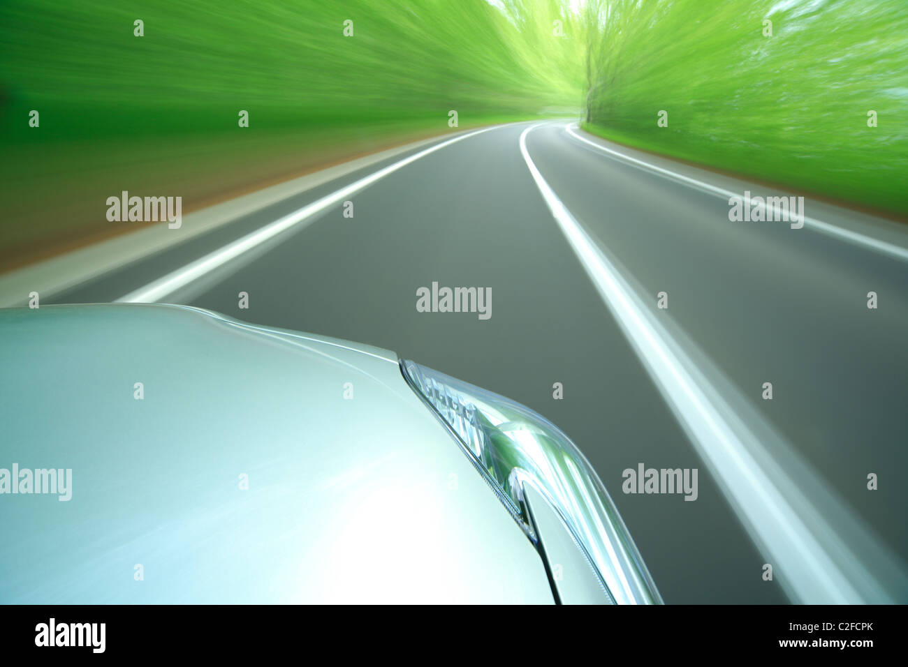 car driving fast into forest Stock Photo - Alamy
