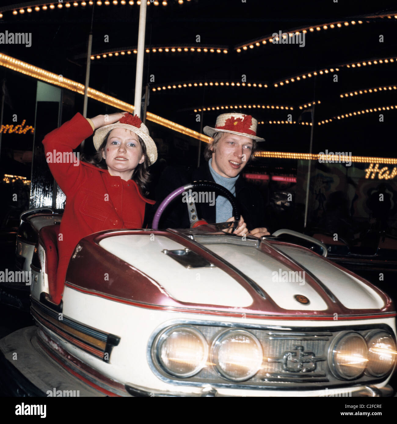 Seventies, people, freetime, kermess, young couple in a dodgem car ...