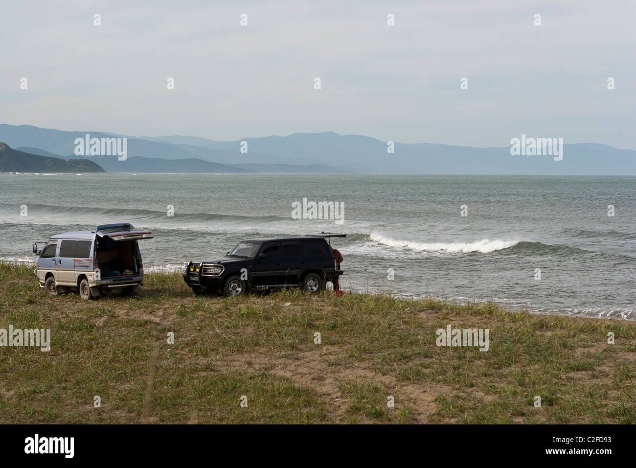 People enjoy the beach in Okhotsk, Sakhalin, Russia. September 2005 ...