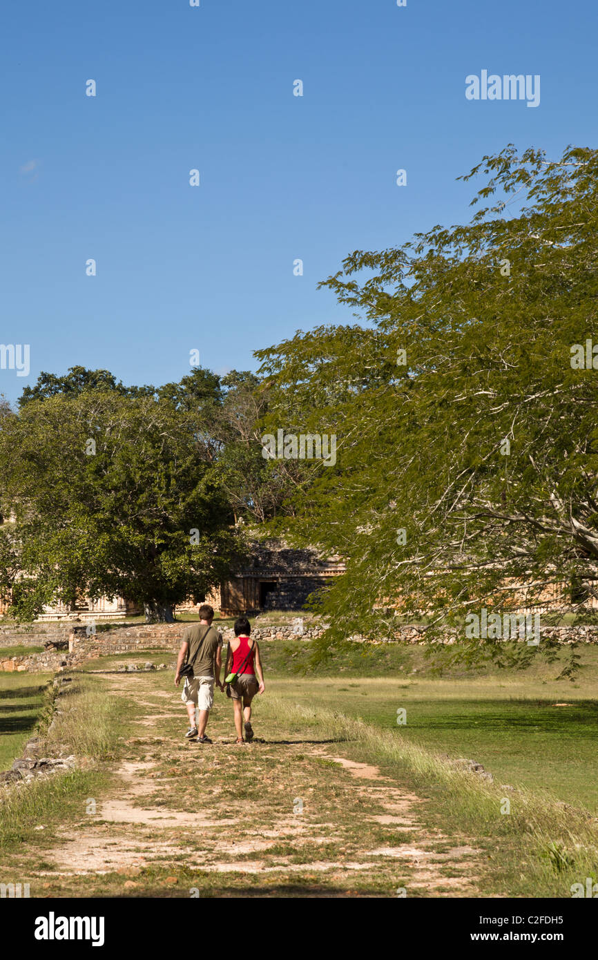 Couple walking together along the sacbe at the Maya ruins of Labna ...