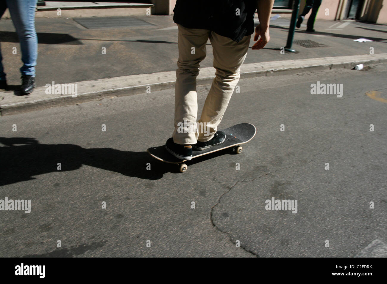 skateboarder in action on street road in city town Stock Photo - Alamy