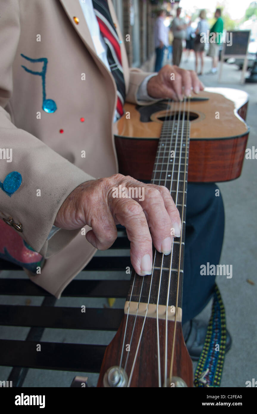 Gospel singer Lester Parrish plays his guitar on the sidewalks of the ...