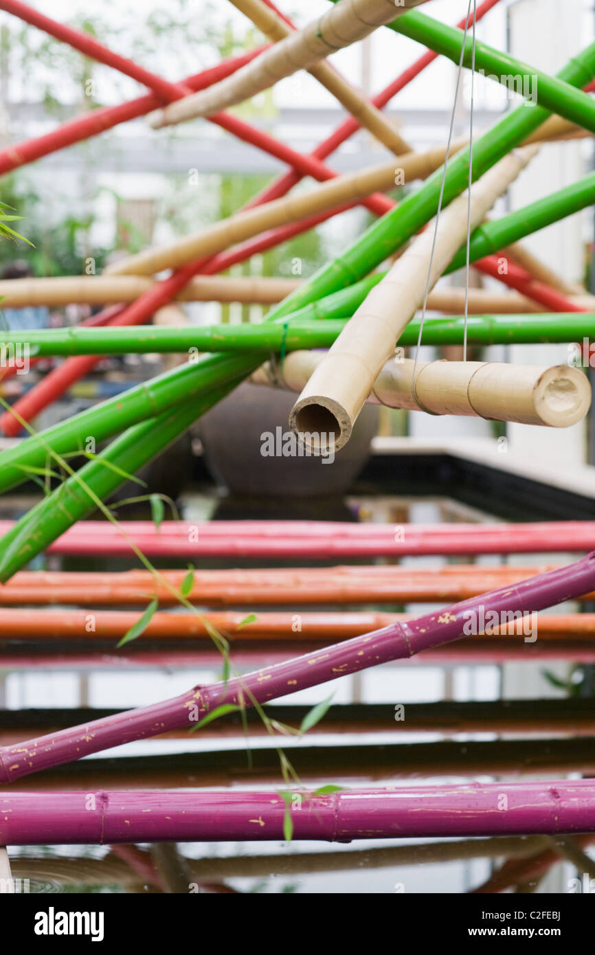 Colored bamboo poles creative arranged Stock Photo - Alamy