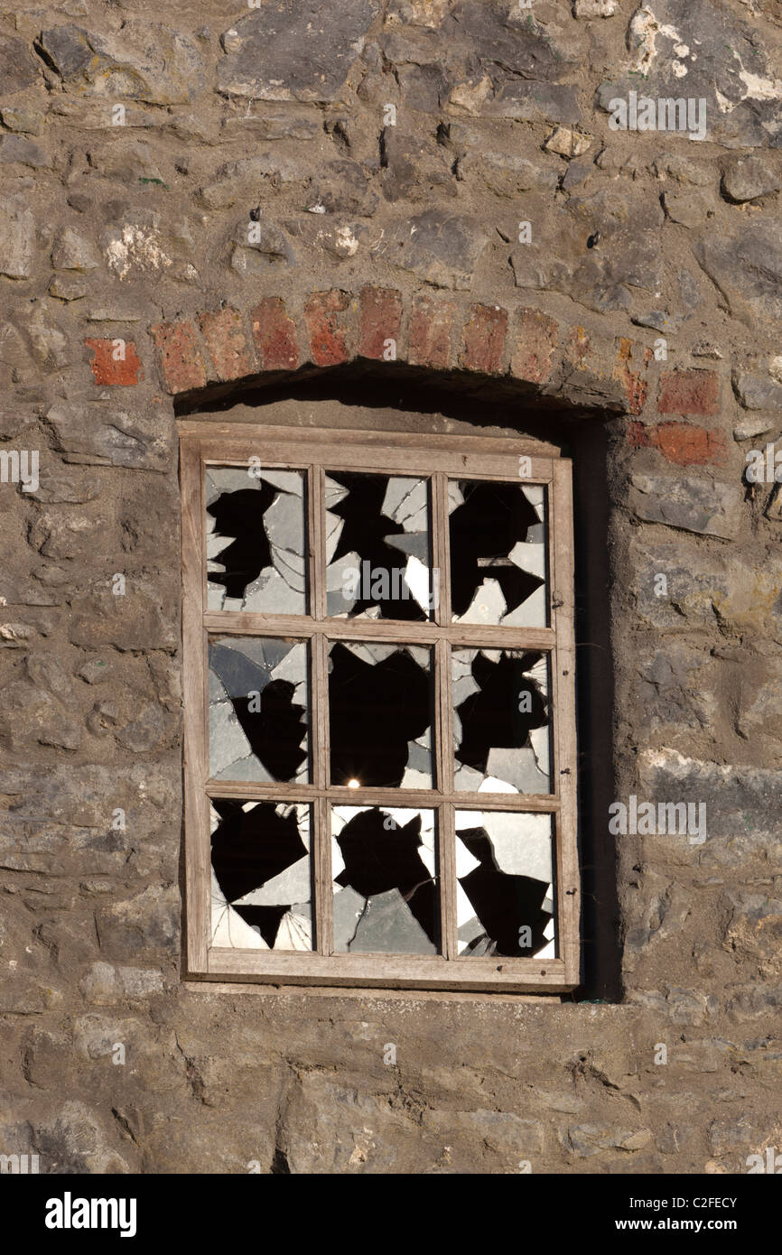 Smashed window of derelict mill Stock Photo - Alamy