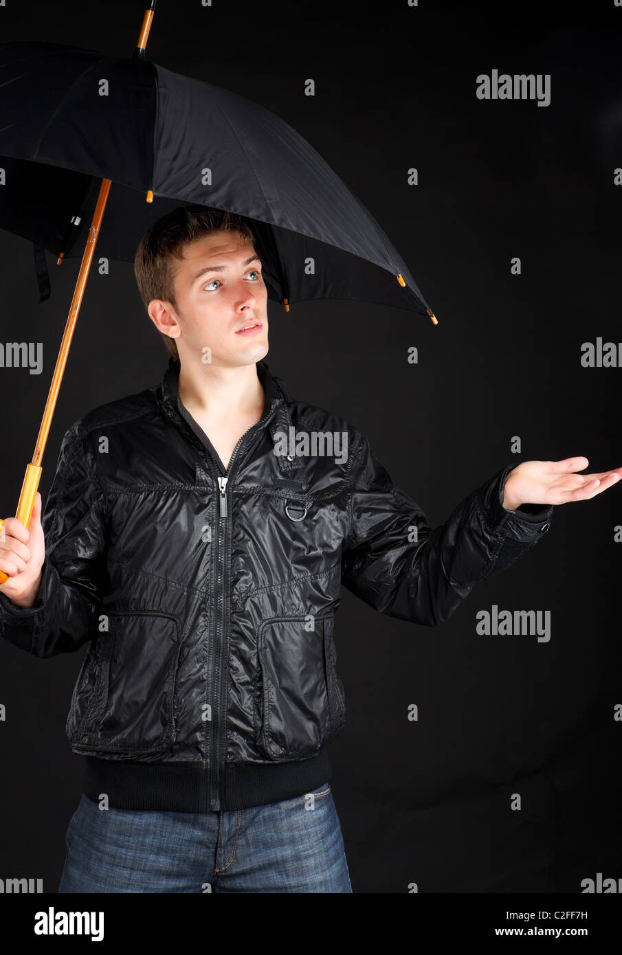 Young man with umbrella Stock Photo - Alamy
