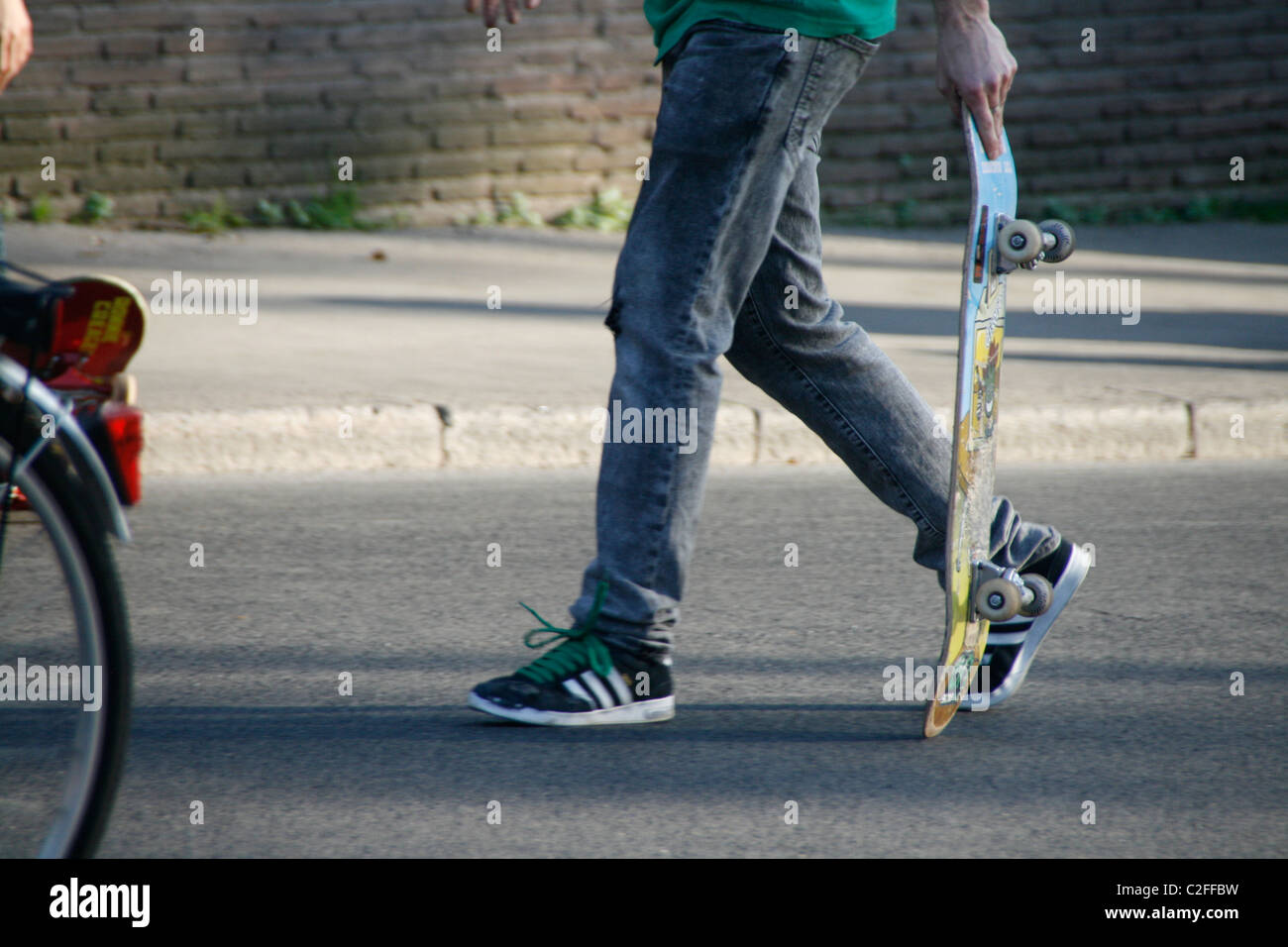skateboarder in action on street road in city town Stock Photo - Alamy