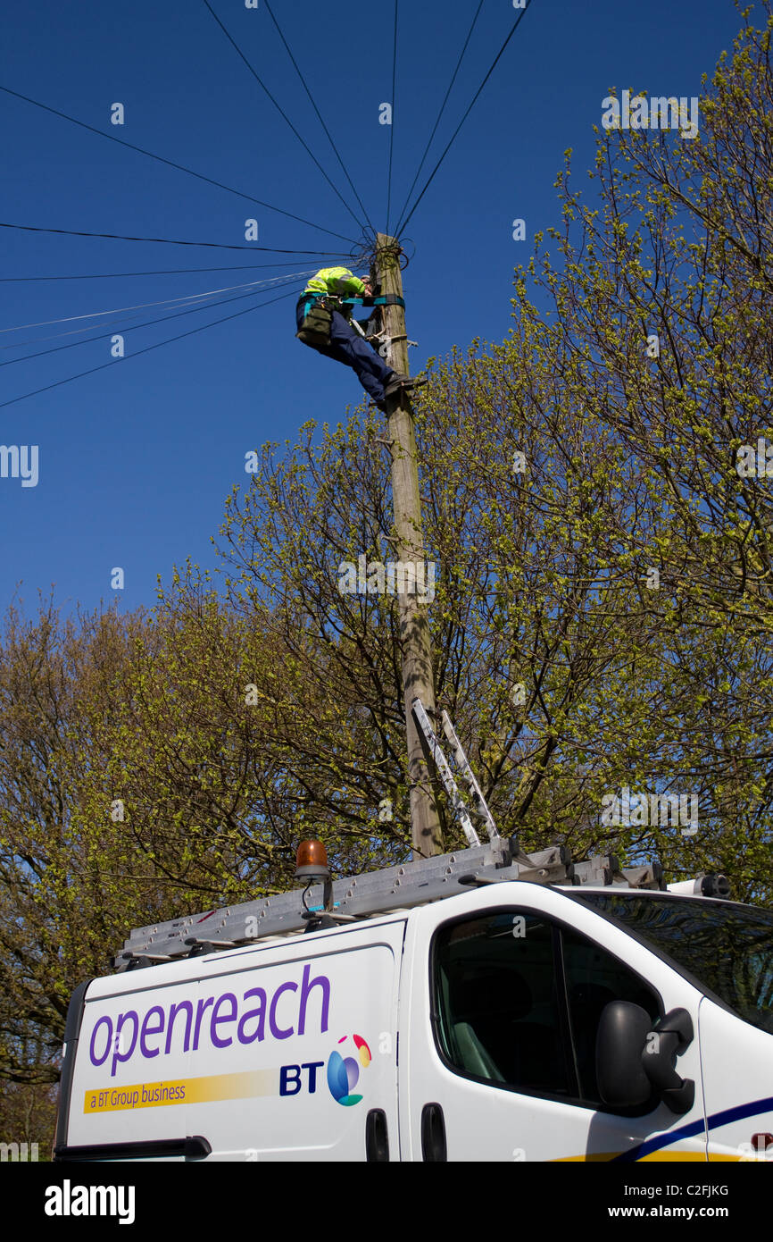 BT Openreach; BT Engineer attending to overhead wires on telegraph pole ...