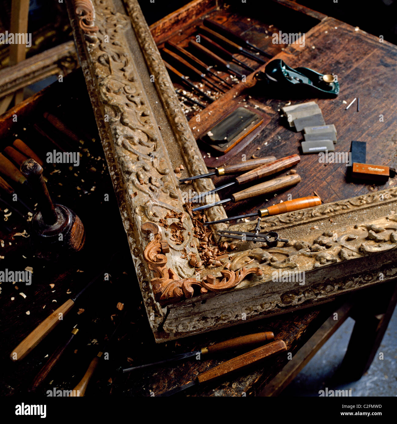 Carving repair to antique French frame in Arnold Wiggins workshop Stock ...
