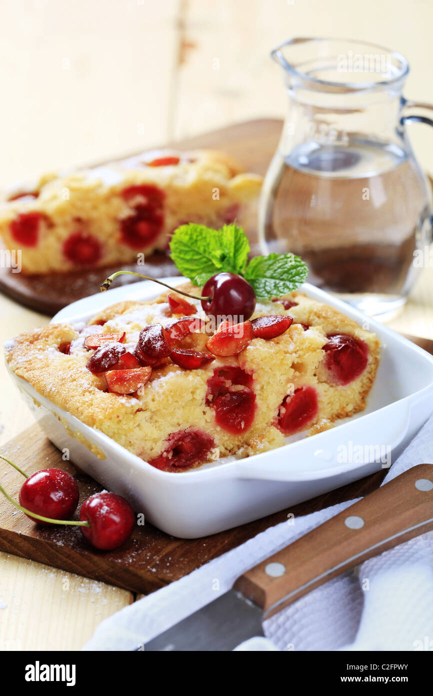 Cherry sponge cake in a square porcelain dish Stock Photo - Alamy