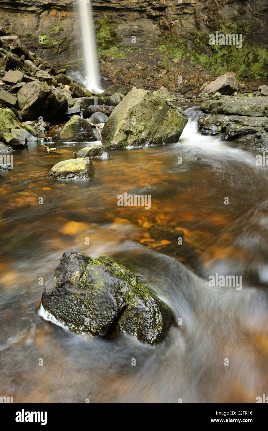 Water running through rocks at the foot of Hardraw Force, the highest ...