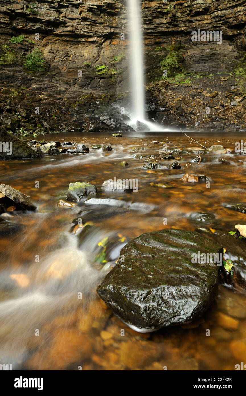 Water running through rocks at the foot of Hardraw Force, the highest ...