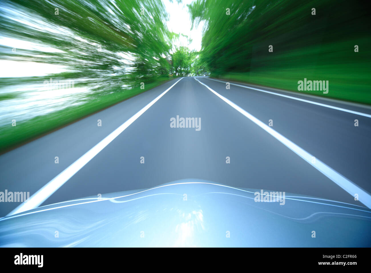 car driving fast into forest Stock Photo - Alamy