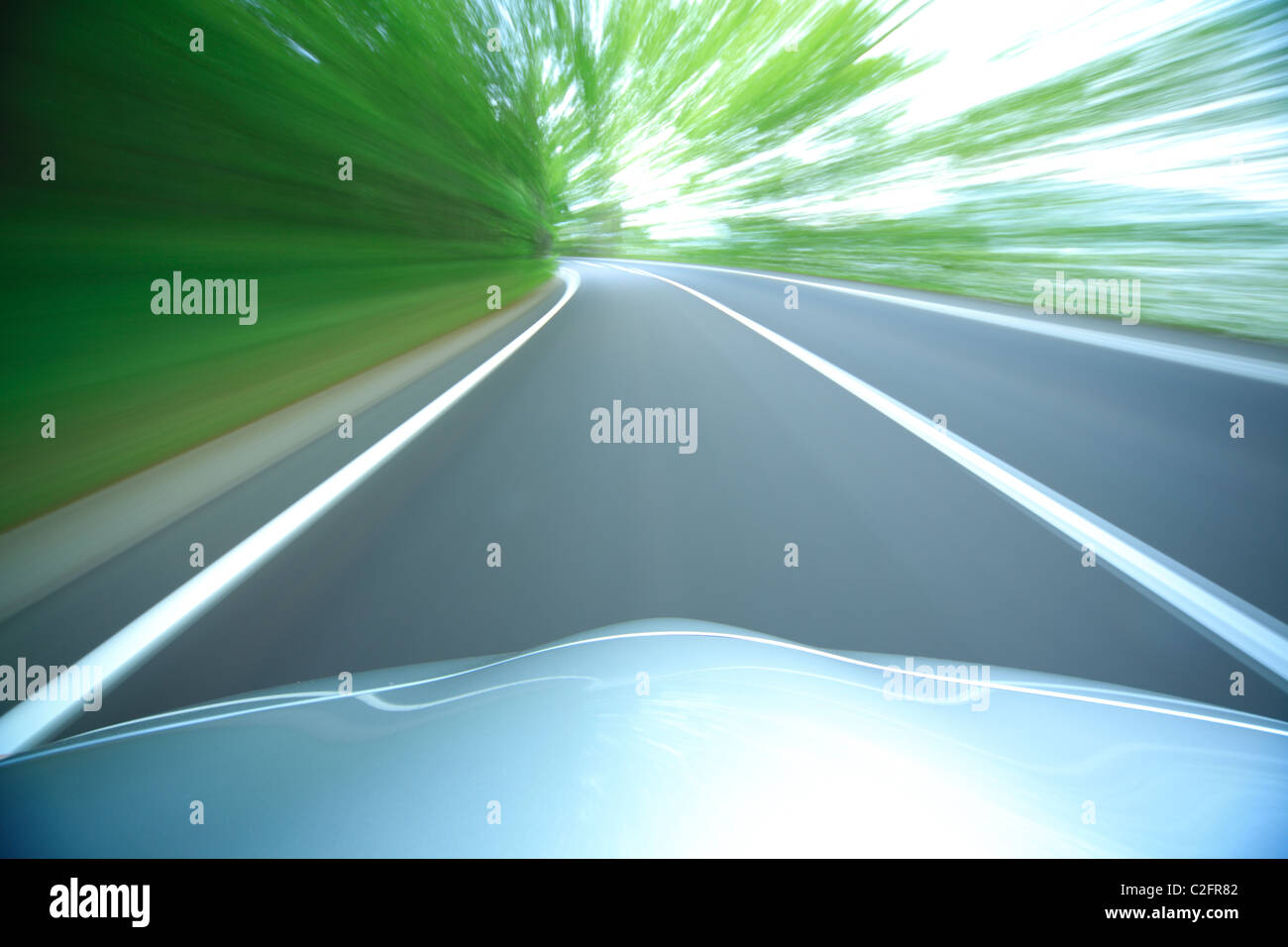 car driving fast into forest Stock Photo - Alamy