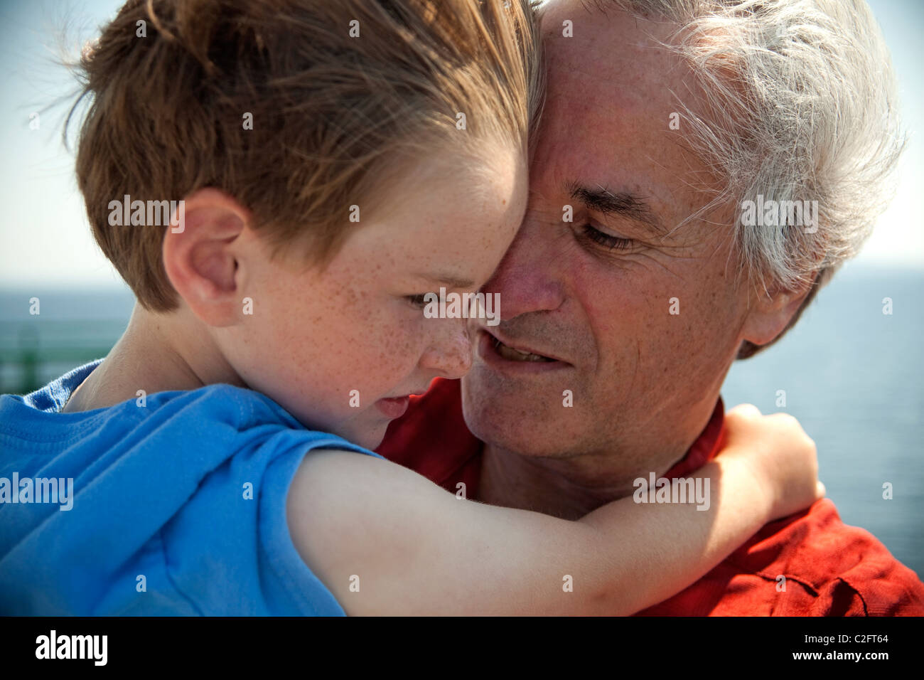 Father and his 4 year old son enjoying a quiet moment while on a ferry ...