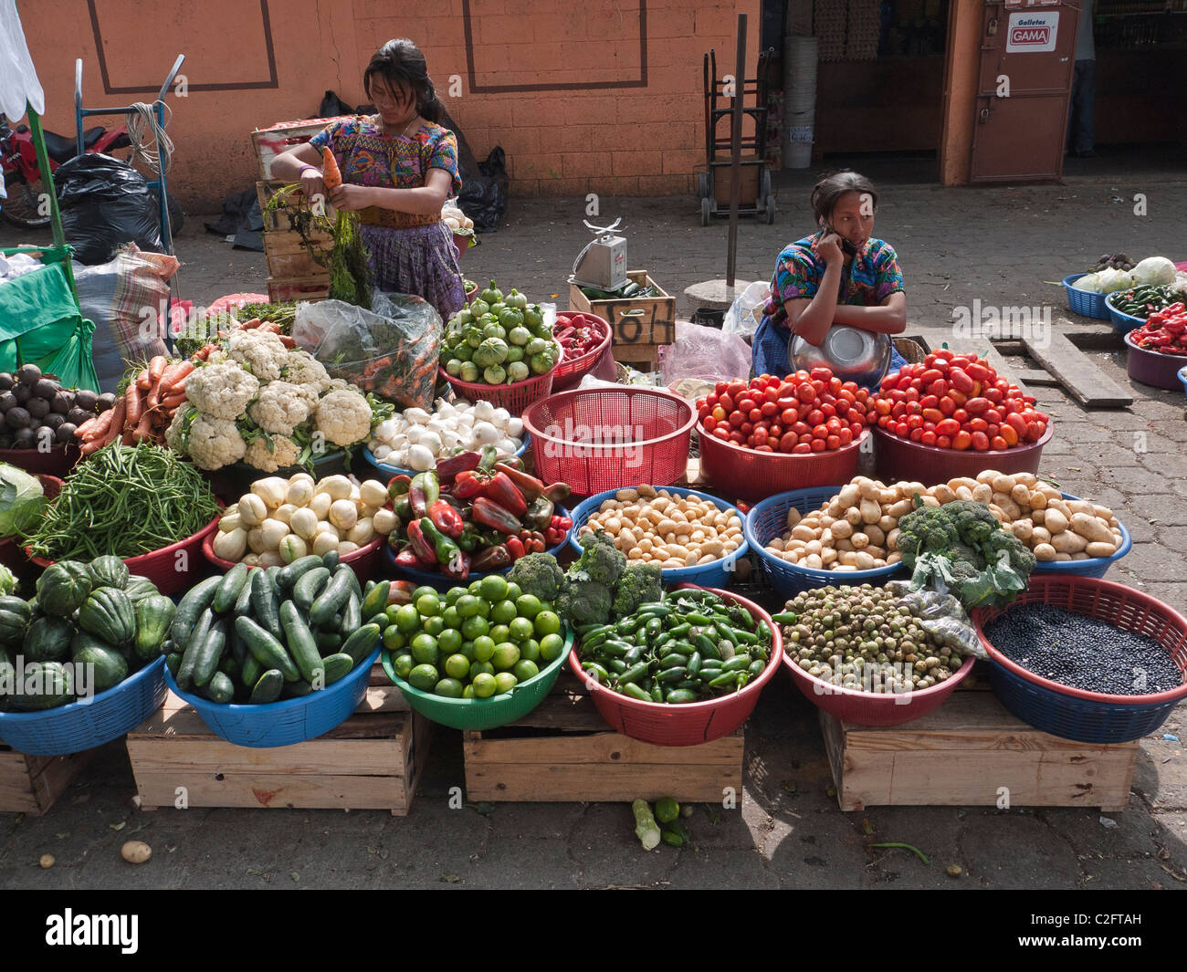 Two women tend to their vegetable stall at the public outside market in ...