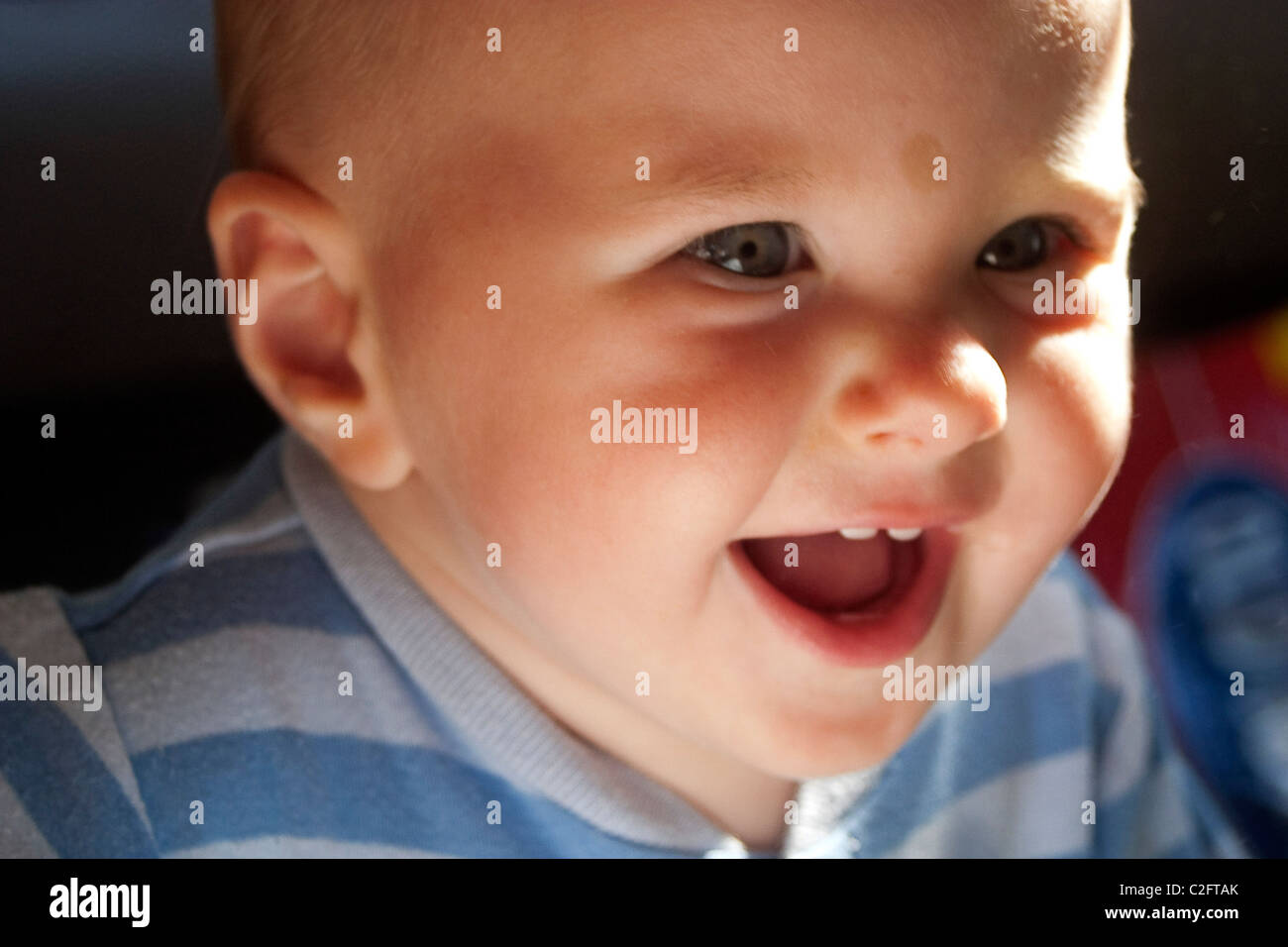 An infant baby boy laughing, happy, and energetic Stock Photo - Alamy