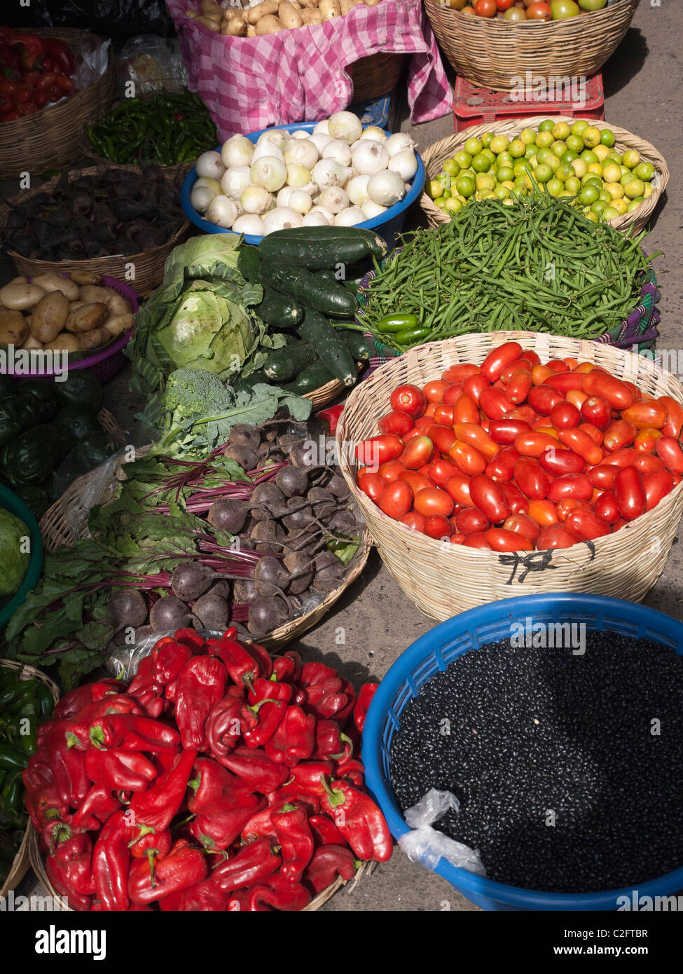 Baskets of fresh and very colorful vegetables on display in the bright ...