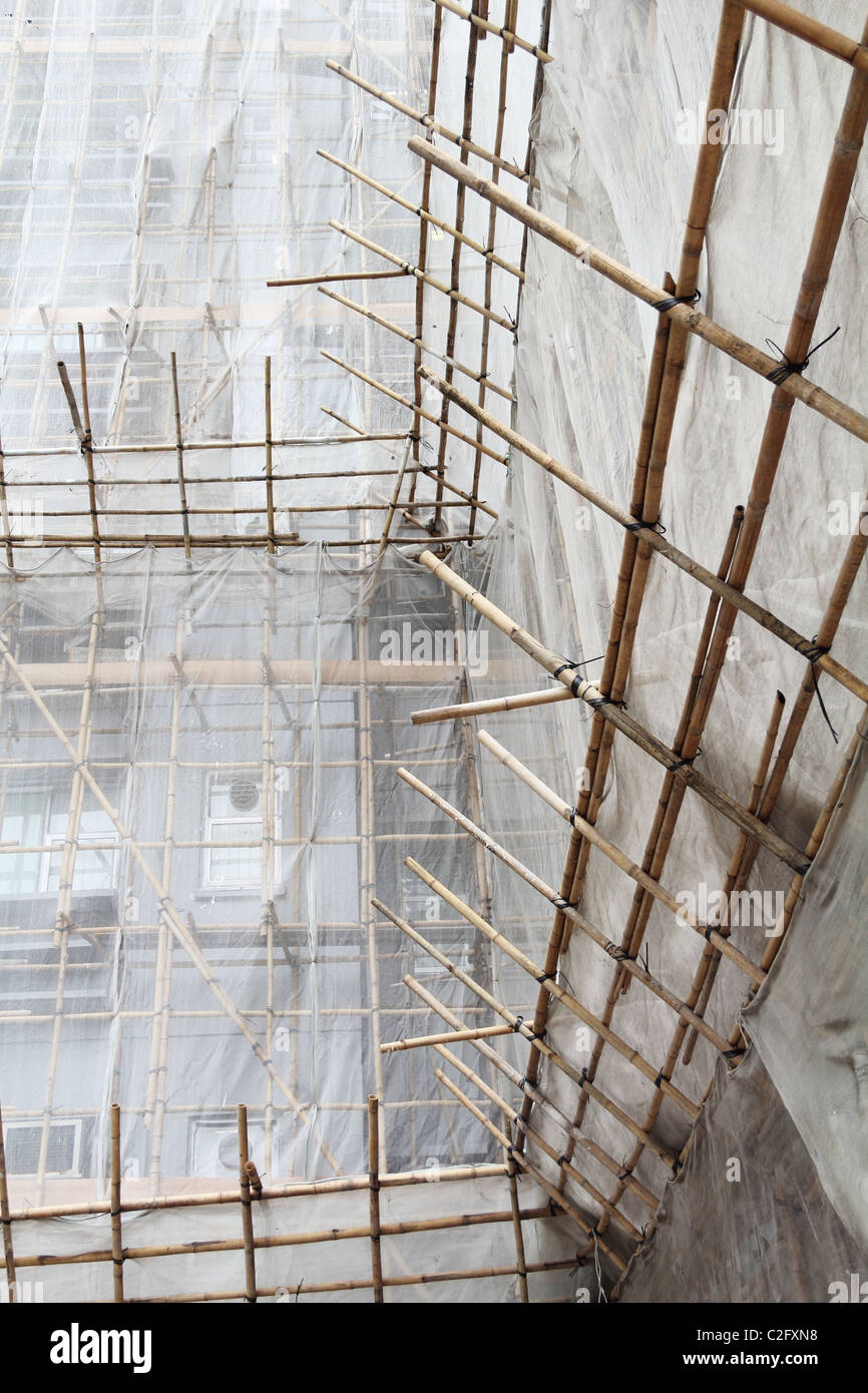 building under construction with bamboo scaffolding and gauze Stock ...