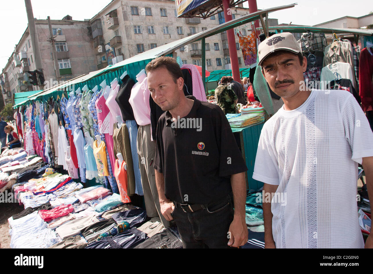 Men sell clothes in an outdoor market in Kholmsk, Sakhalin, Russia ...