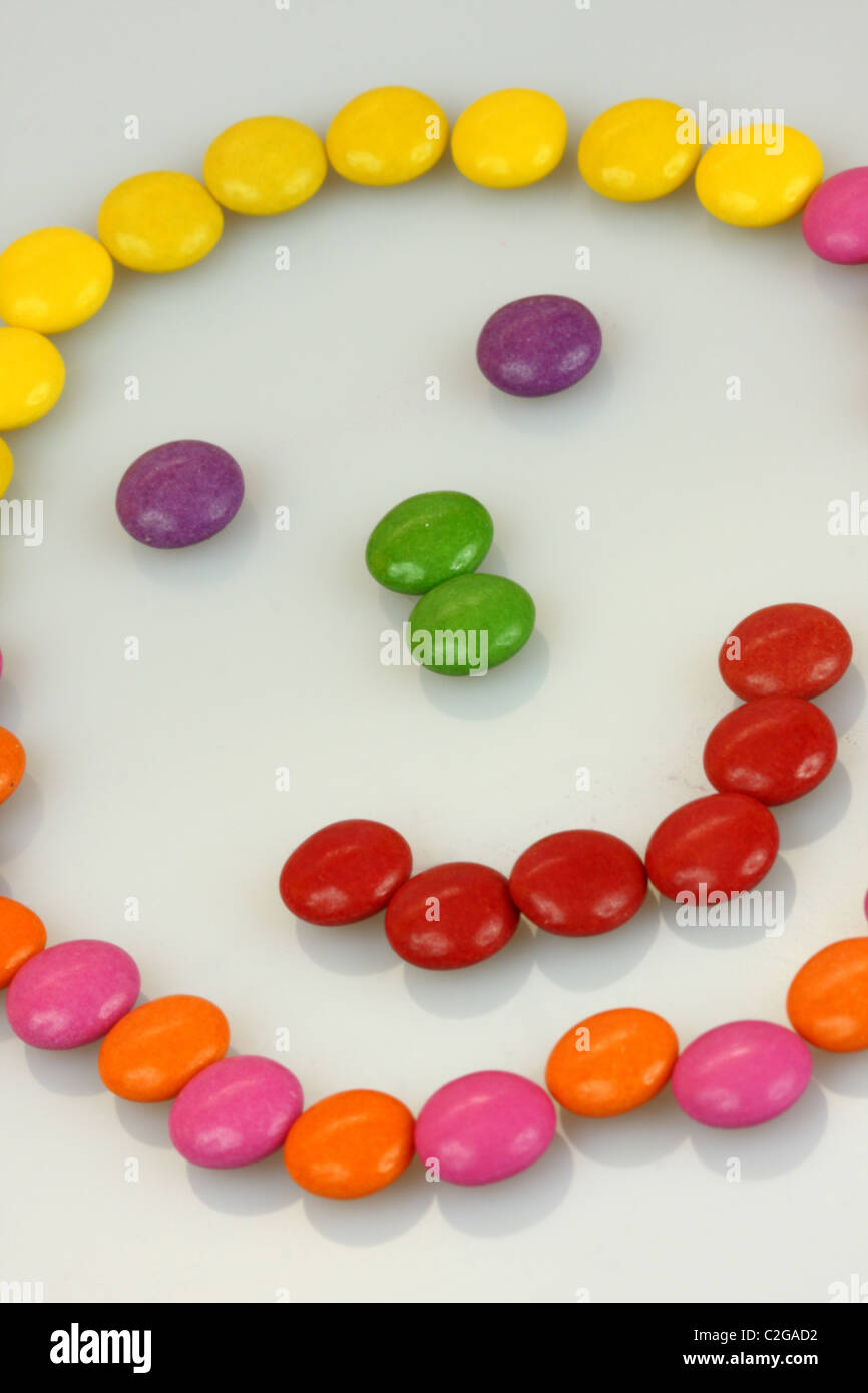 Happy face made of colorful candies Stock Photo - Alamy
