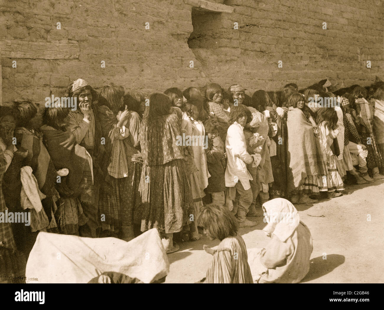 Line of Apache men, women, and children outside agency building on ...
