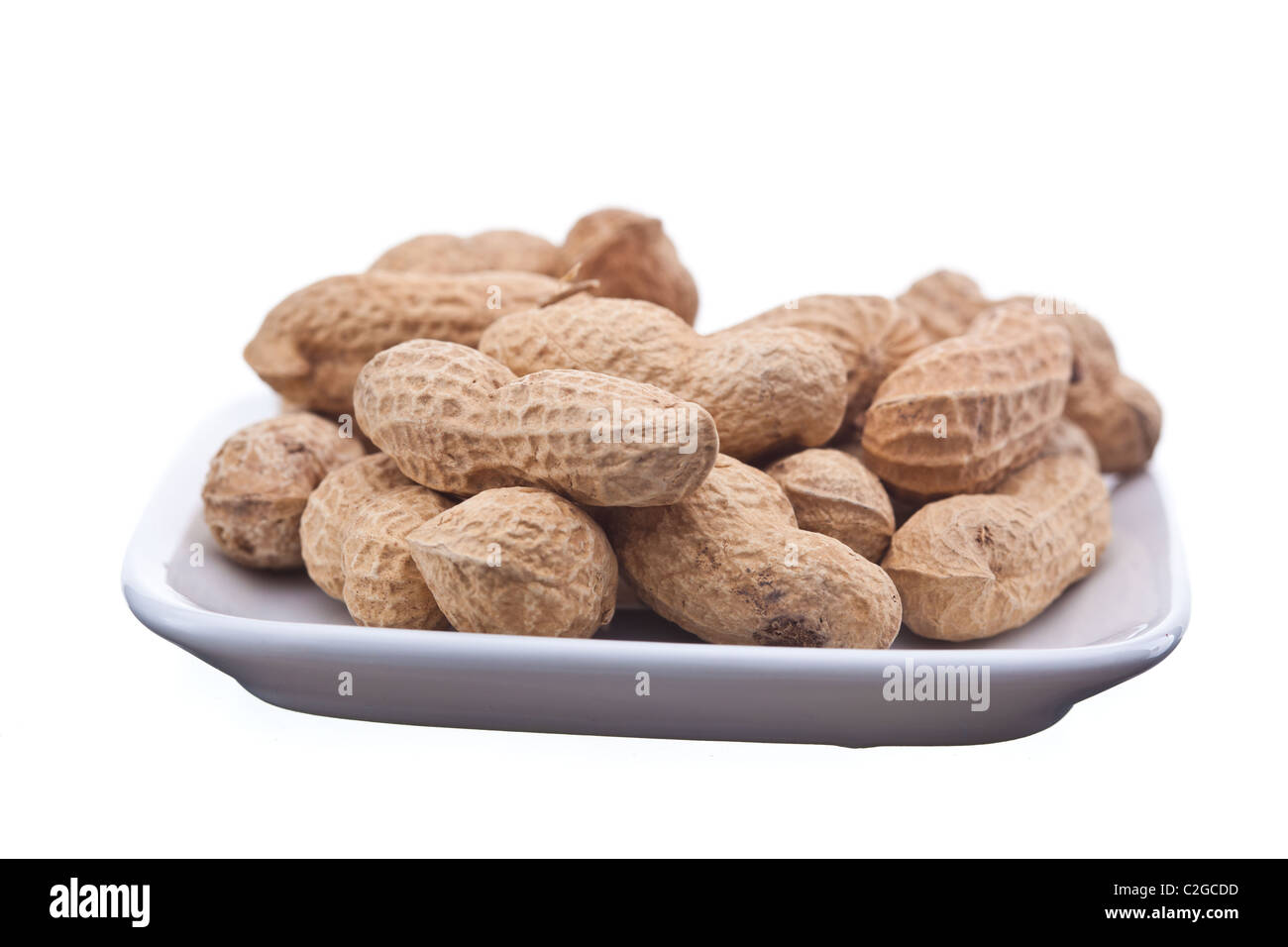 Roasted peanuts on plate Stock Photo - Alamy