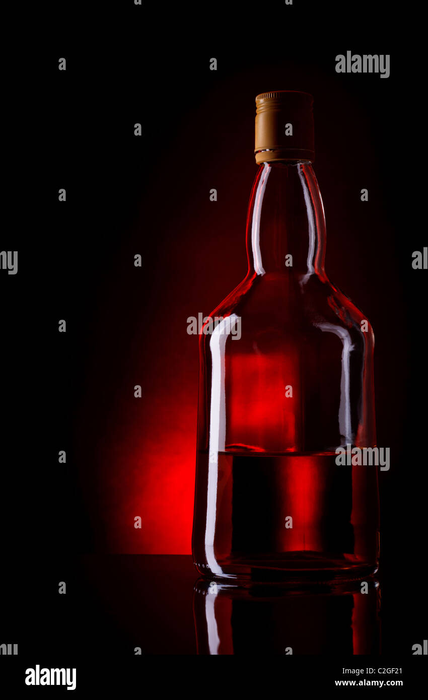 bottle of whiskey on deep red background Stock Photo - Alamy