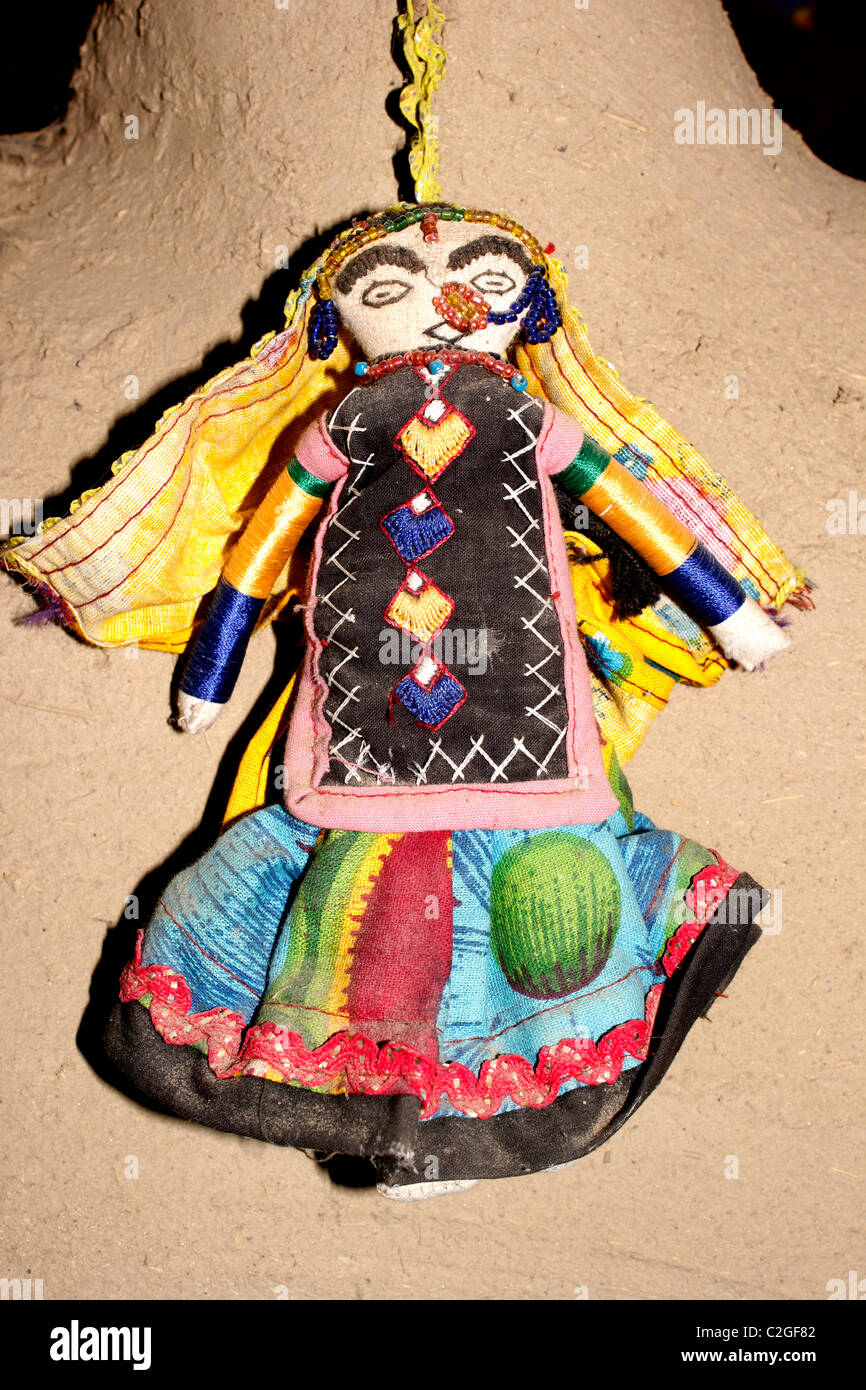 A doll hanging on a mud wall Stock Photo - Alamy