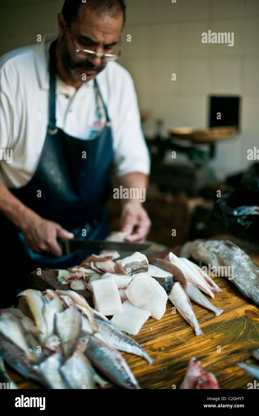 A fishmonger prepares some fillets in Marrakesh Stock Photo - Alamy