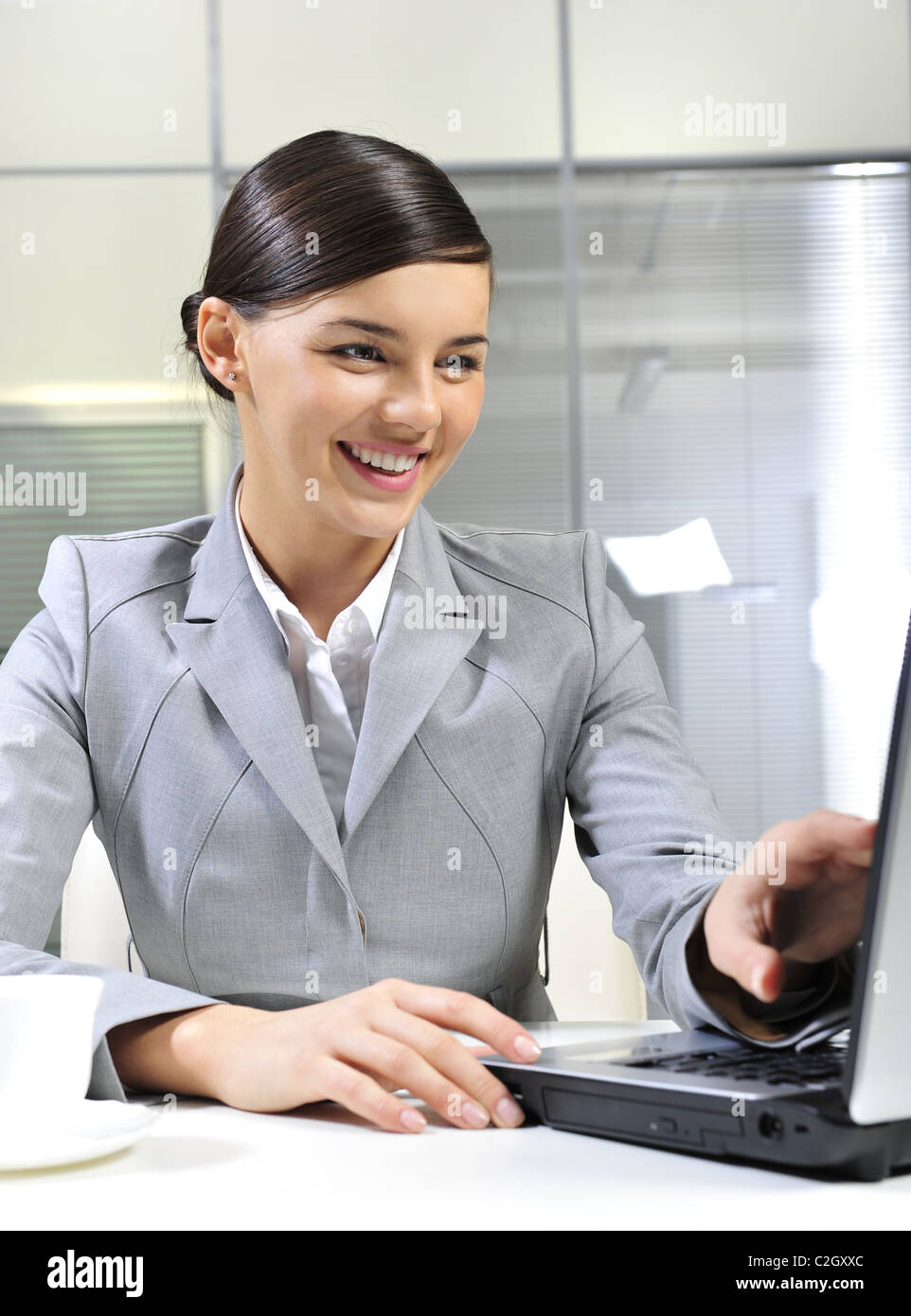 Beautiful business woman thinking about something while working on ...