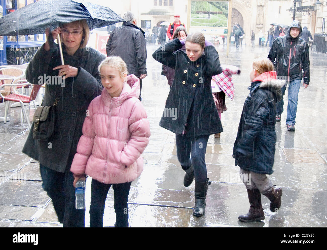 A family running in heavy rain Stock Photo - Alamy
