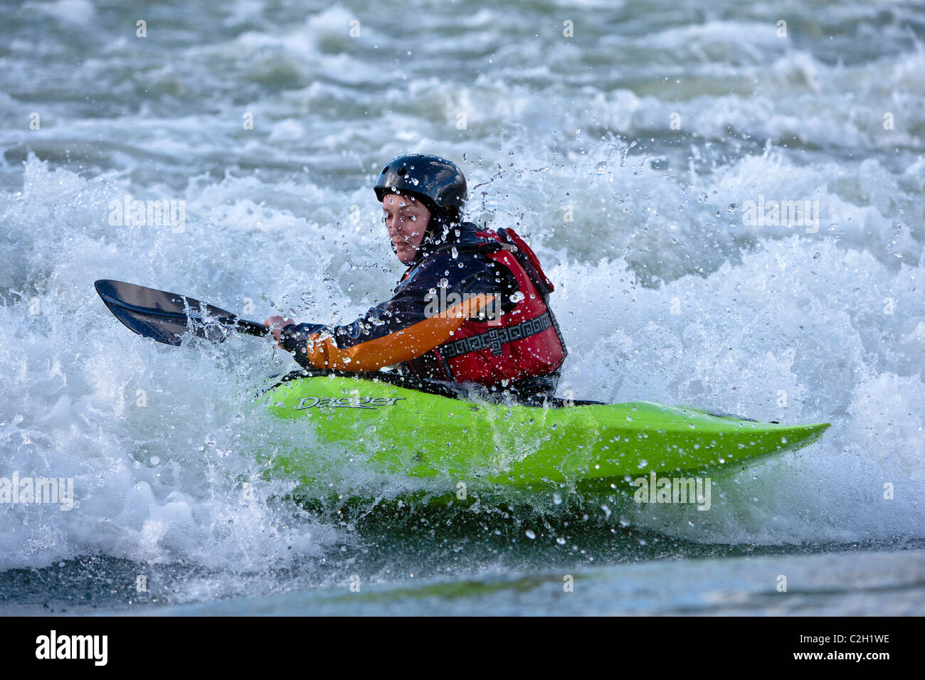 Female playboating whitewater kayaker during backsurf on wave, Rhone ...