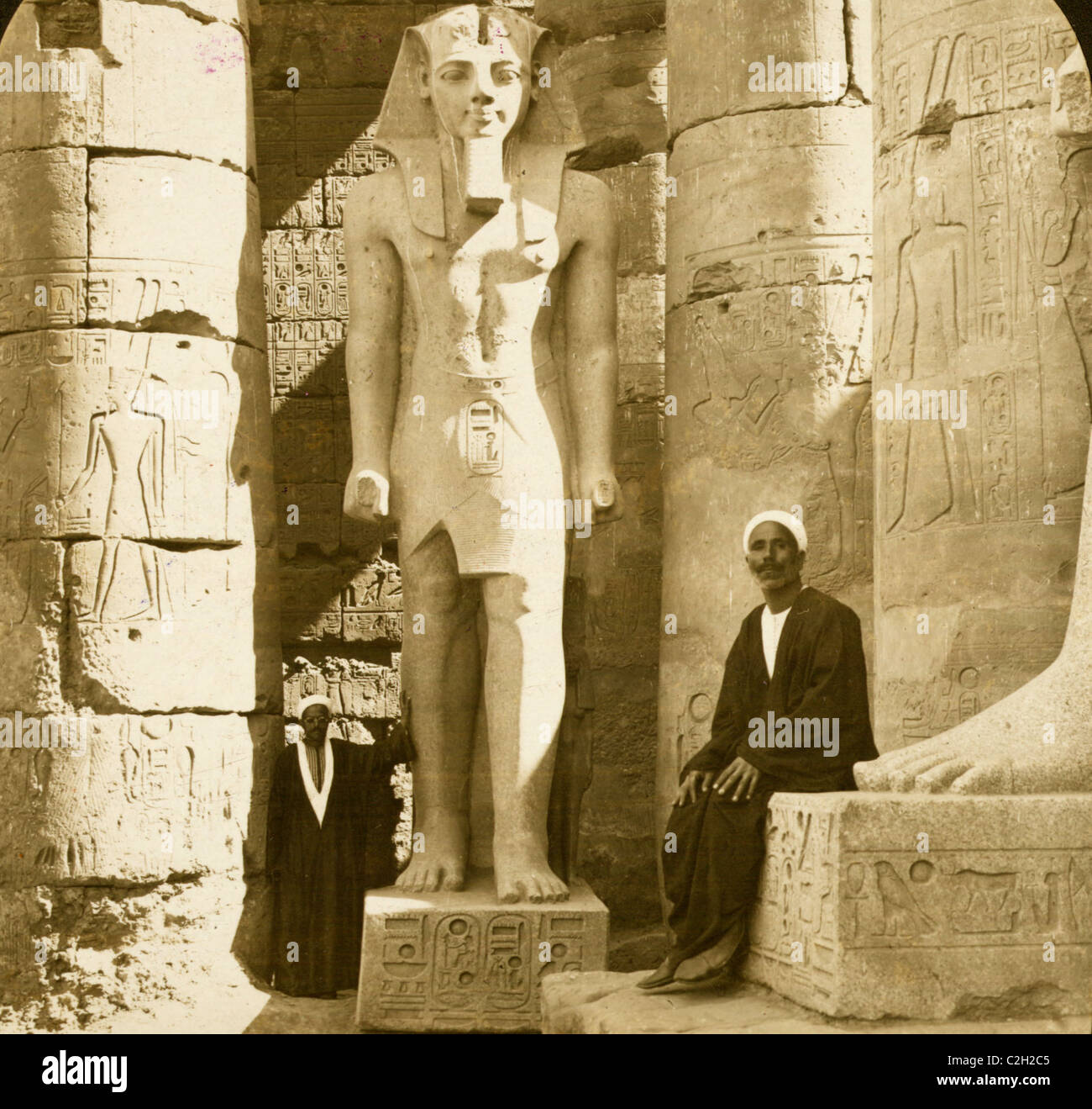 Colossal statue of Ramses II among the columns of the Temple of Luxor ...