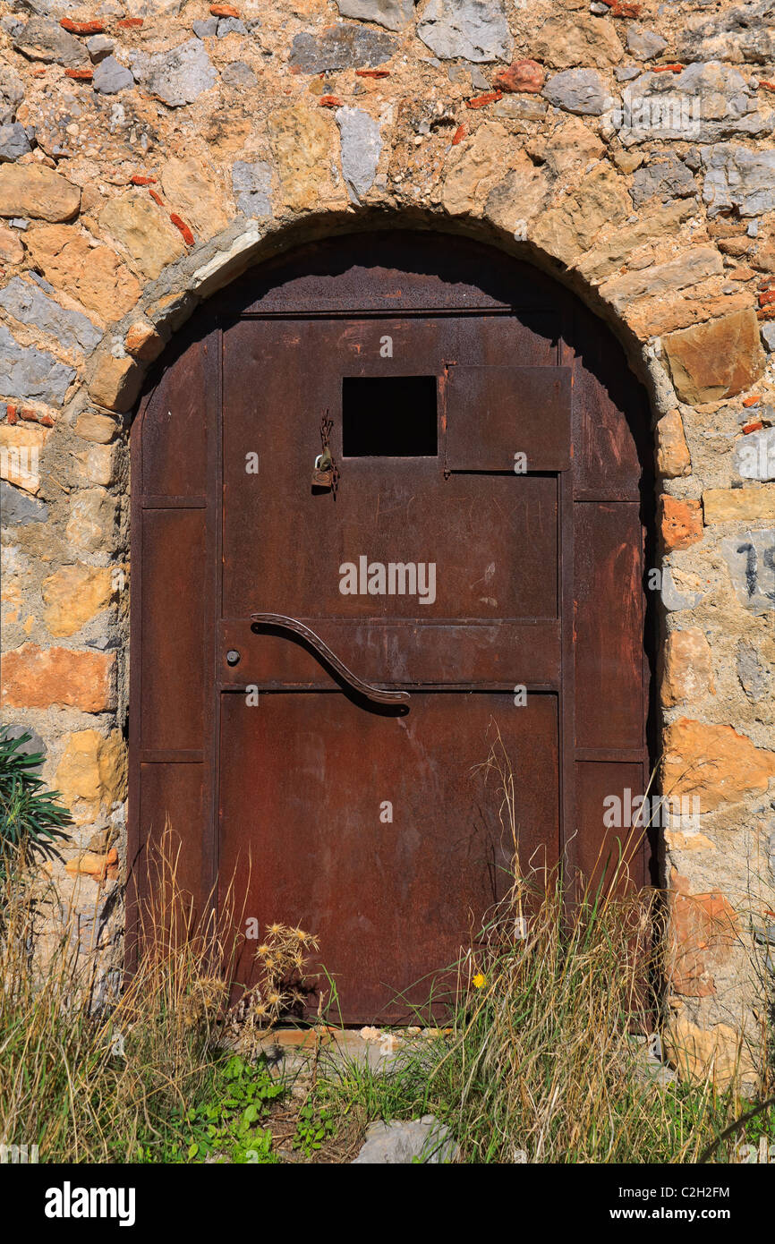 Locked and sealed rusty door in Mani Stock Photo - Alamy
