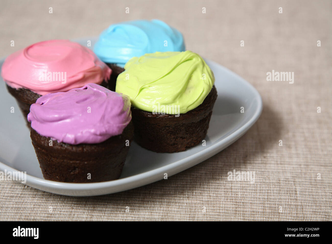 Cupcakes With Colored Icing Stock Photo - Alamy
