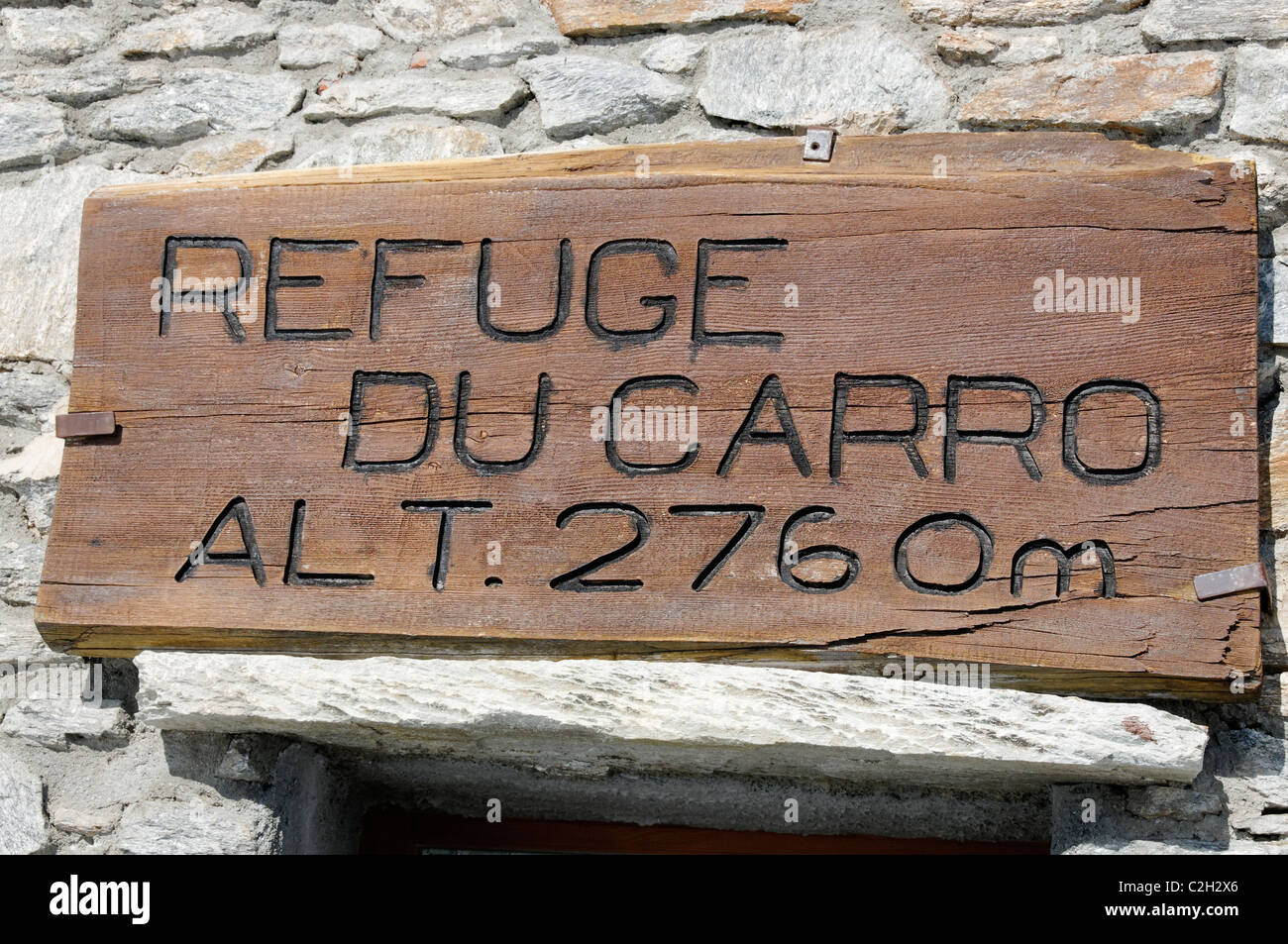 A name sign above an alpine hut entrance Stock Photo - Alamy