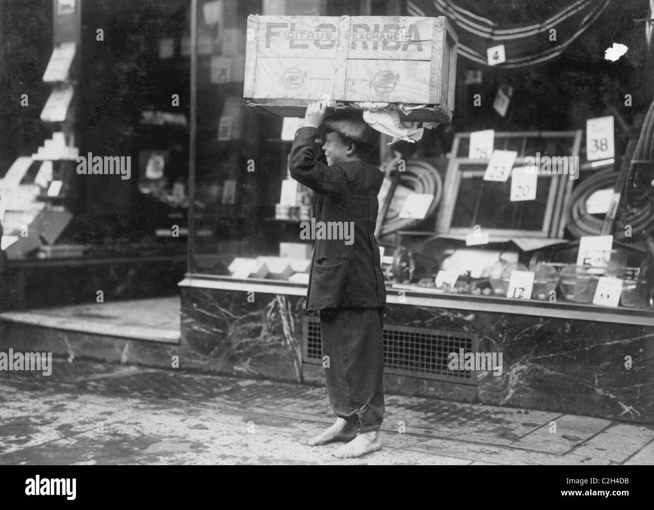 Scavenger hold a box of scavenged wood aloft Stock Photo - Alamy